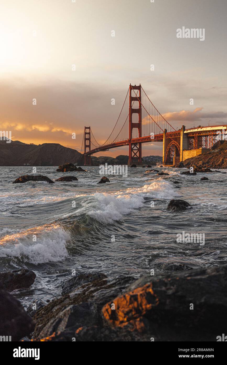 The Golden Gate Bridge spanning over a tranquil body of water during a ...