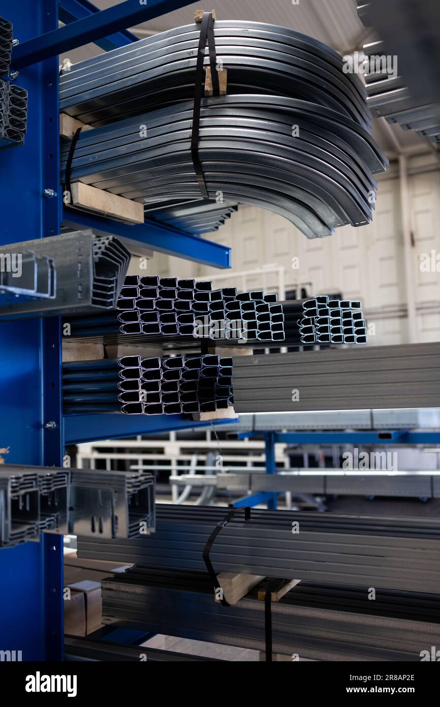 Stock of raw metal materials in a facatory hall (shallow DOF; color ...