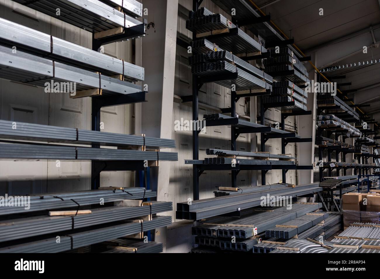 Stock of raw metal materials in a facatory hall (shallow DOF; color ...