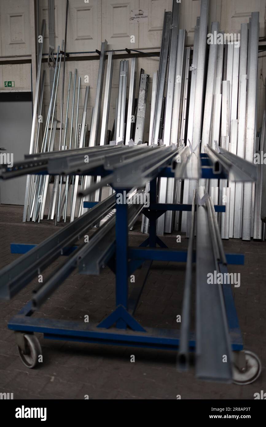 Stock of raw iron metal materials in a factory hall (shallow DOF; color ...