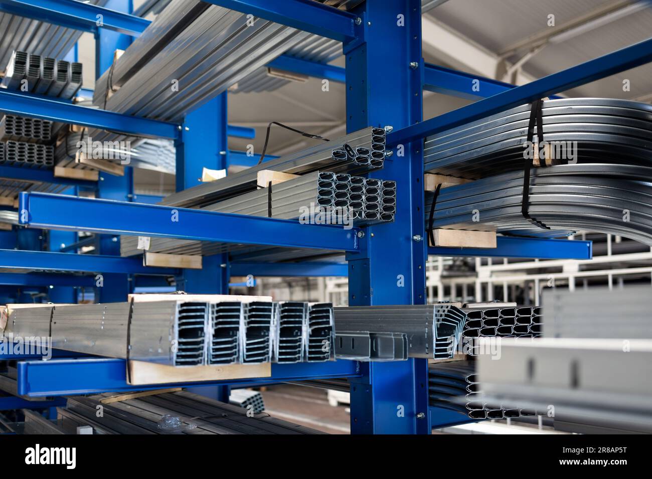 Stock of raw metal materials in a facatory hall (shallow DOF; color ...