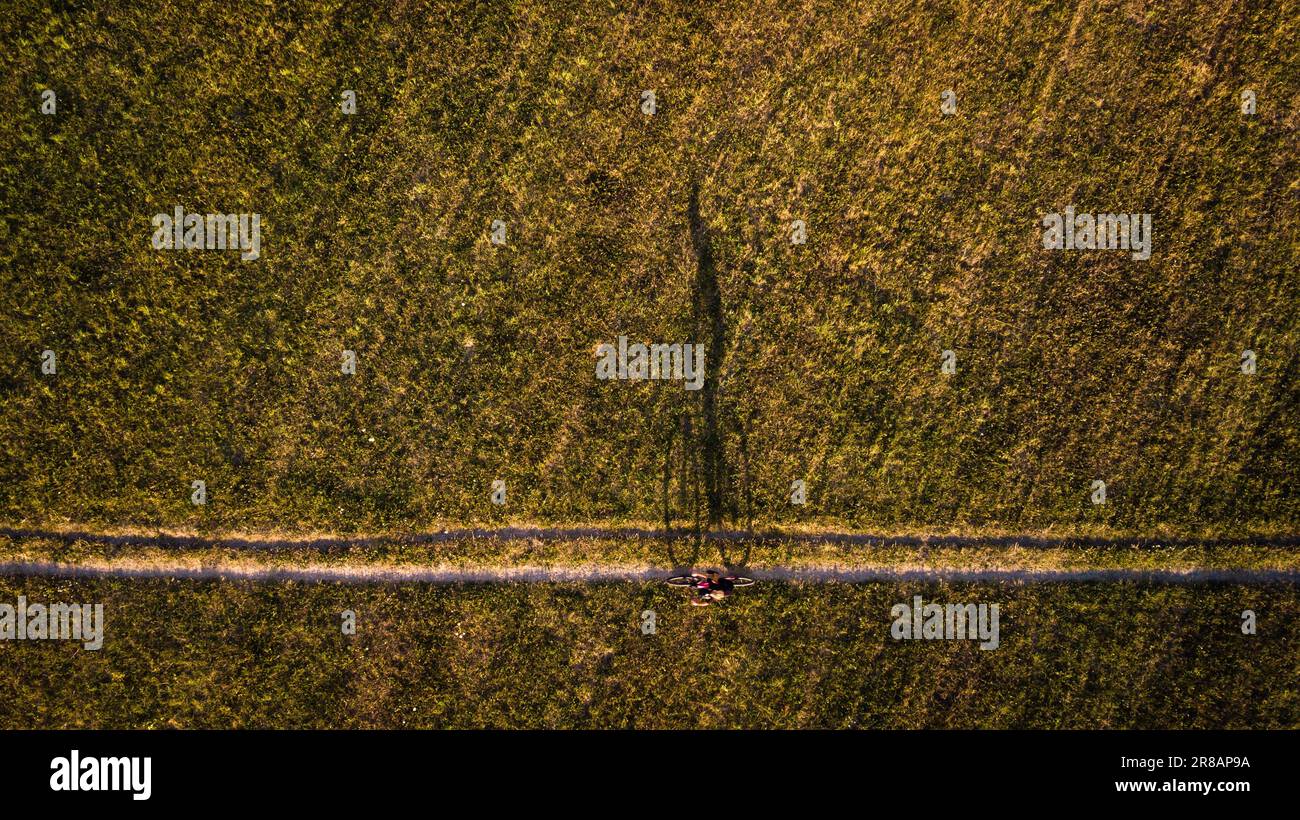 Aerial image of a biker on a mountain bike amid fields outdoors Stock ...