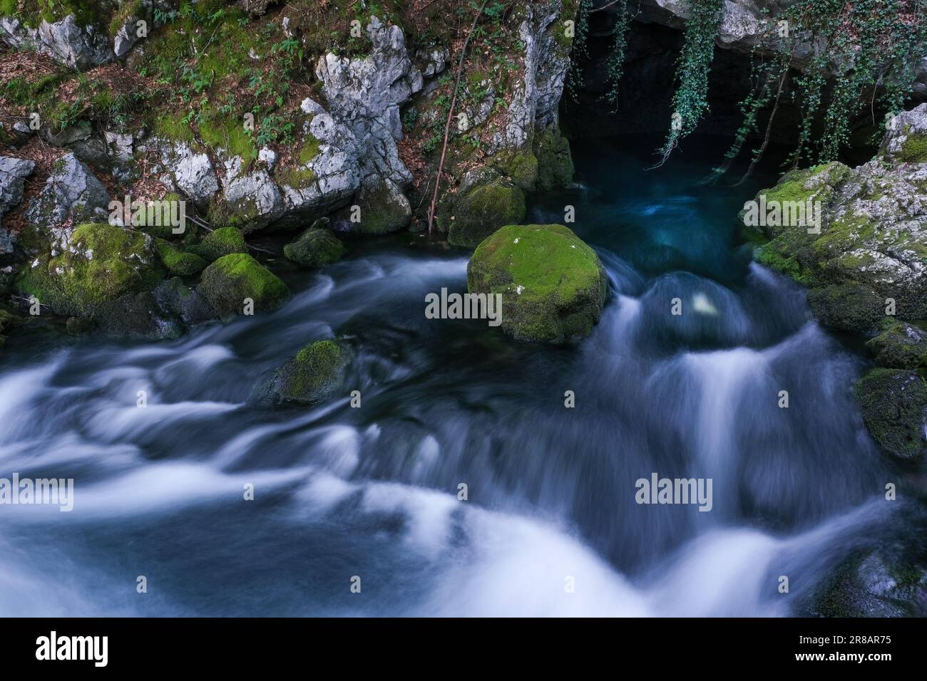 a small river flowing out of a cave at Gollinger Wasserfall (timlapse ...