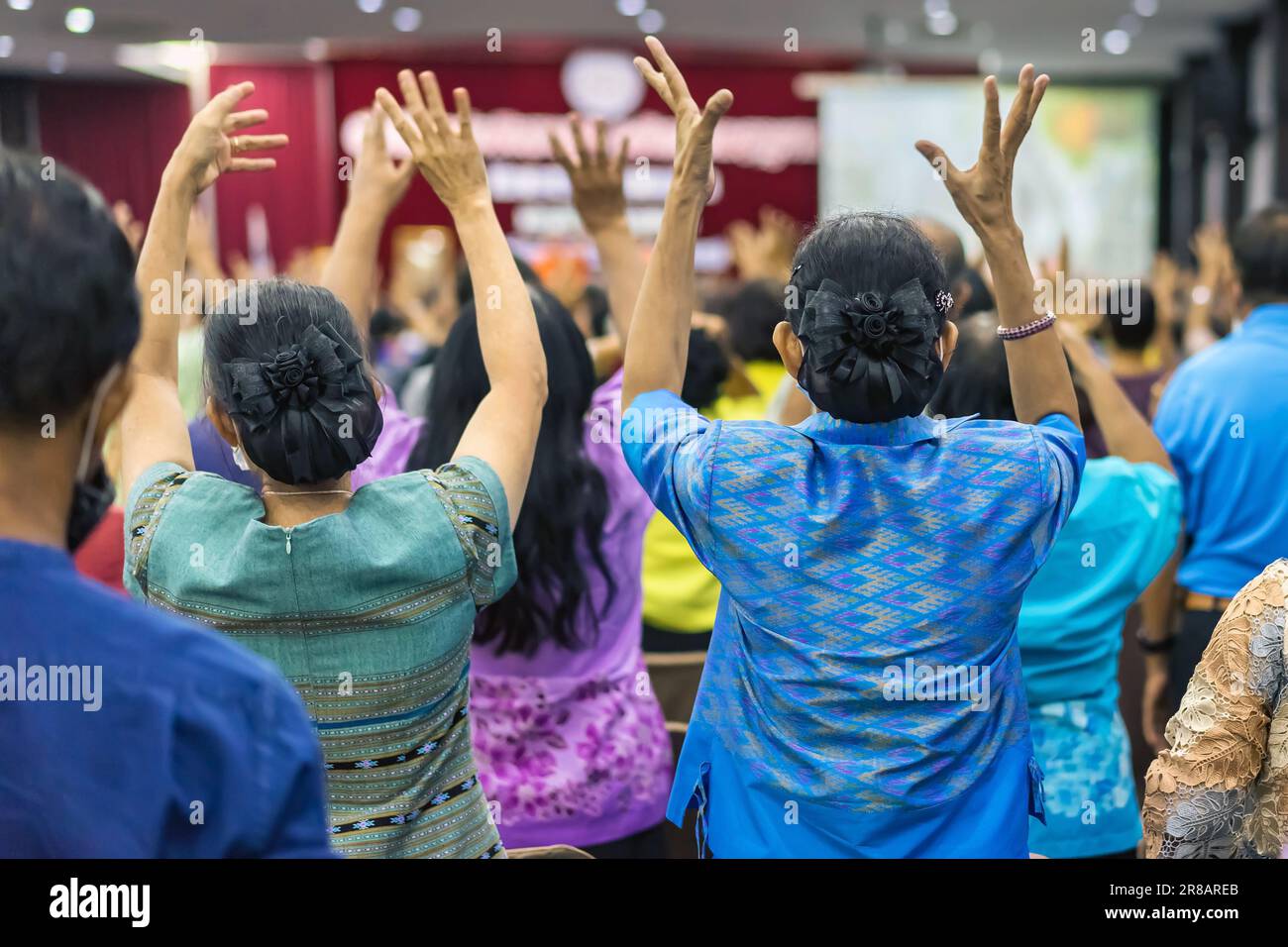 Back view of senior women hands raised to workout and exercise rhythmic ...