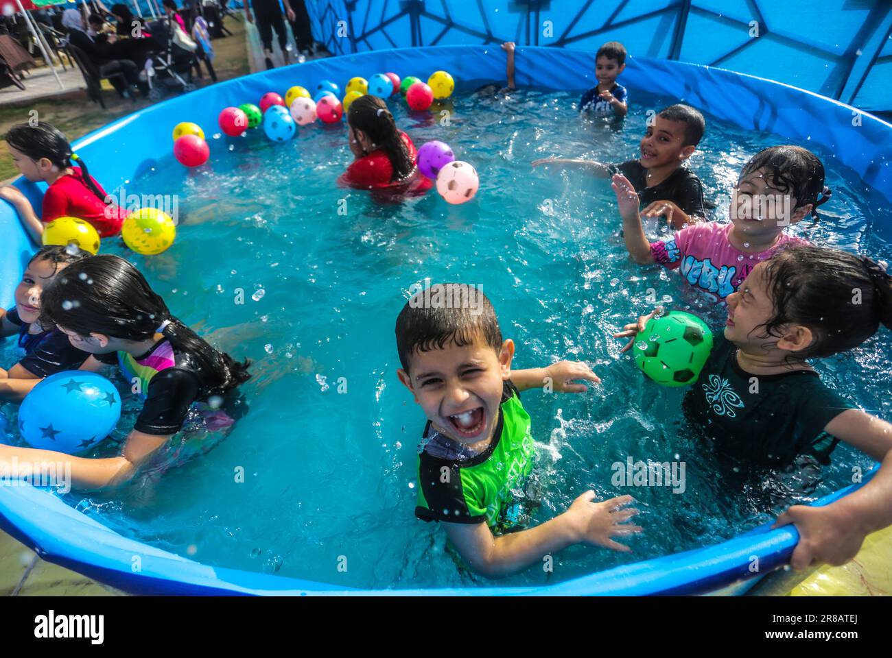 Palestinian children enjoy water games during the summer vacation in ...