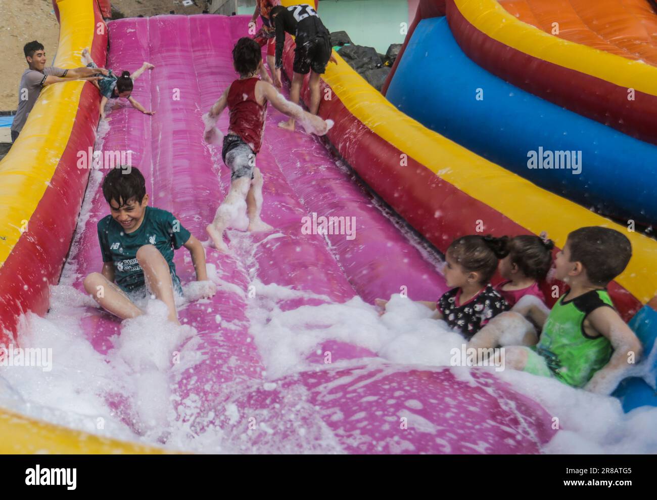 Palestinian children enjoy water games during the summer vacation in ...