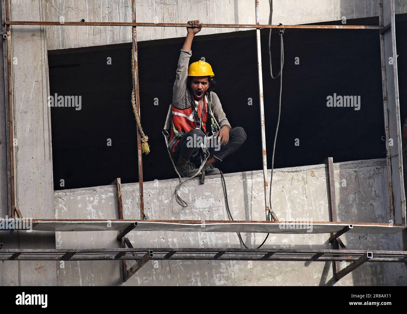 A labourer is seen yawning at a construction site in Mumbai. A labourer ...