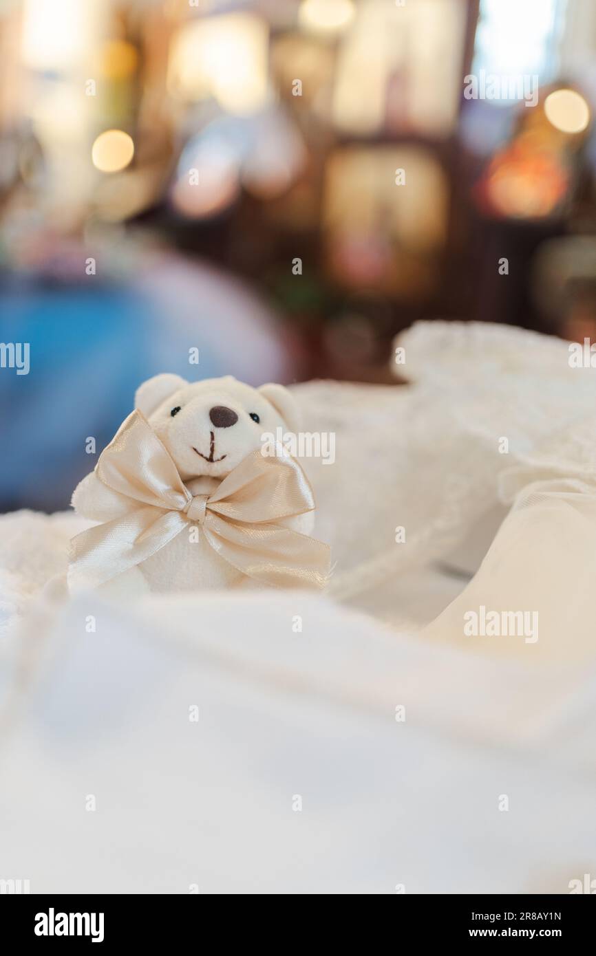 A cozy bedroom interior with a plush, brown teddy bear resting on a ...