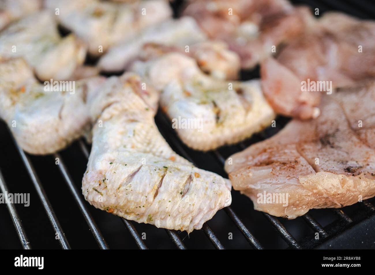 Close-up shot of raw chicken meat being cooked on a hot grill Stock ...