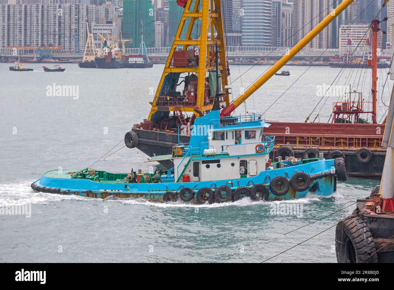 Blue Tugboat With Barge at Victoria Harbour in Hong Kong Stock Photo ...