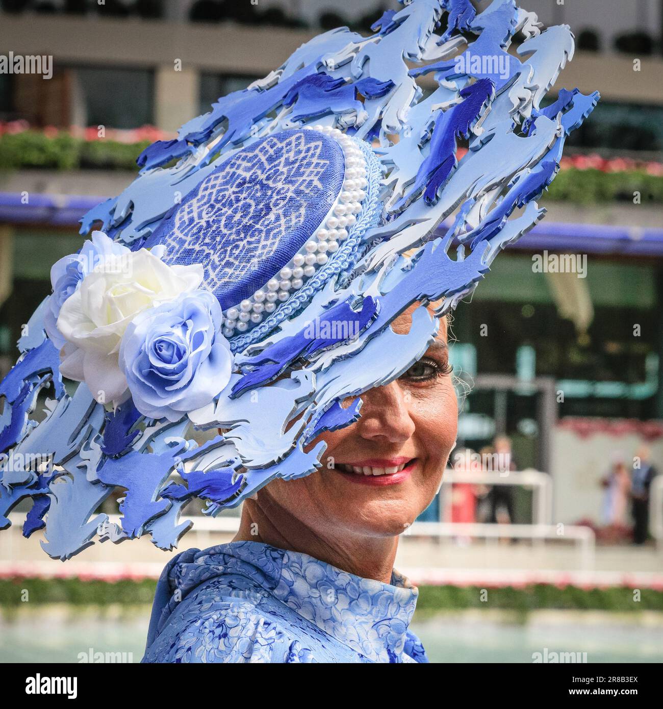 London, UK. 20th June, 2023. A racegoer with hat featuring cut out ...