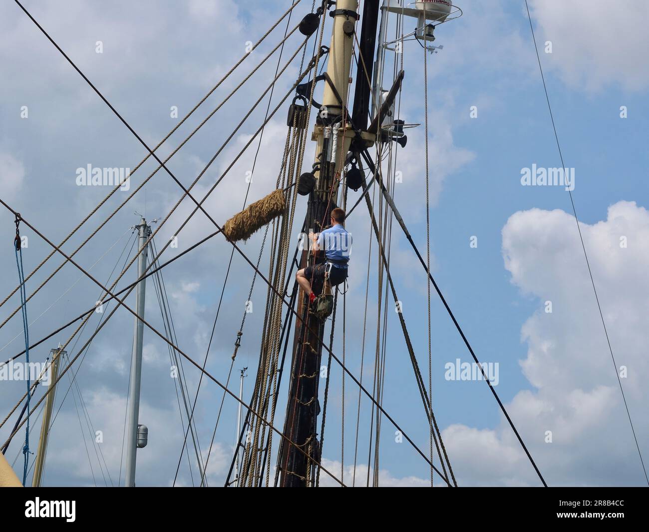 Lowestoft, Suffolk - 19 June 2023 : Man climbing the rigging of a ...