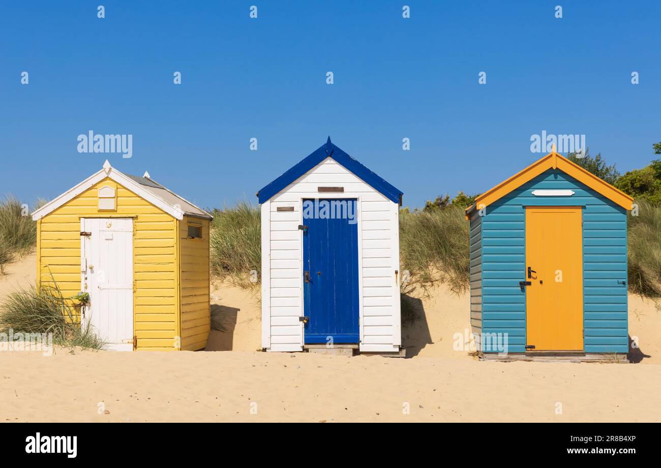 Colourful wooden beach huts on the sandy beach in Southwold, Suffolk ...