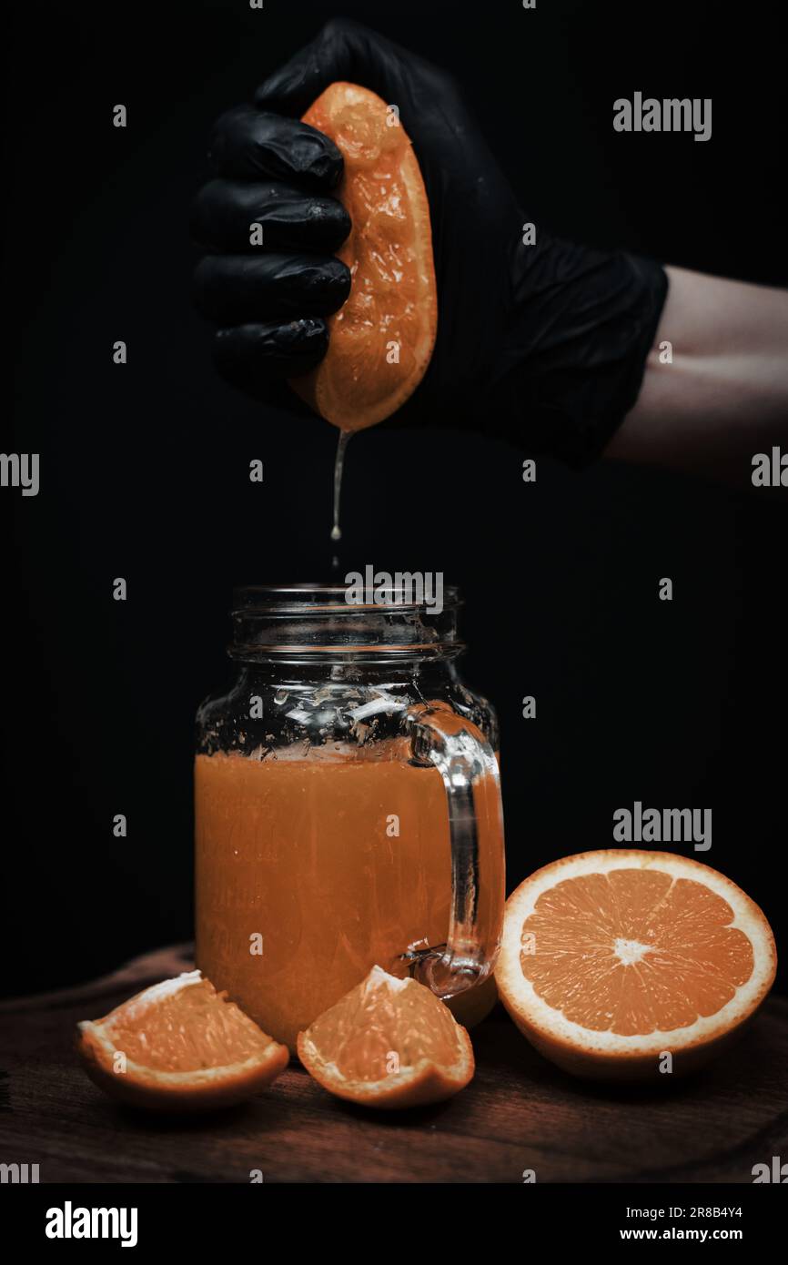A chef crushing orange in glass Stock Photo - Alamy