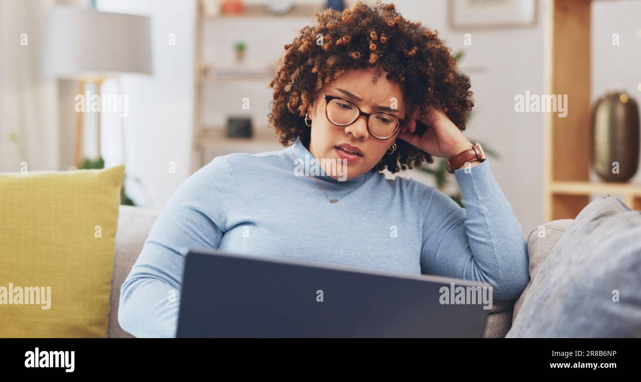 Laptop, bad news and grief with a woman on a sofa in the living room of ...