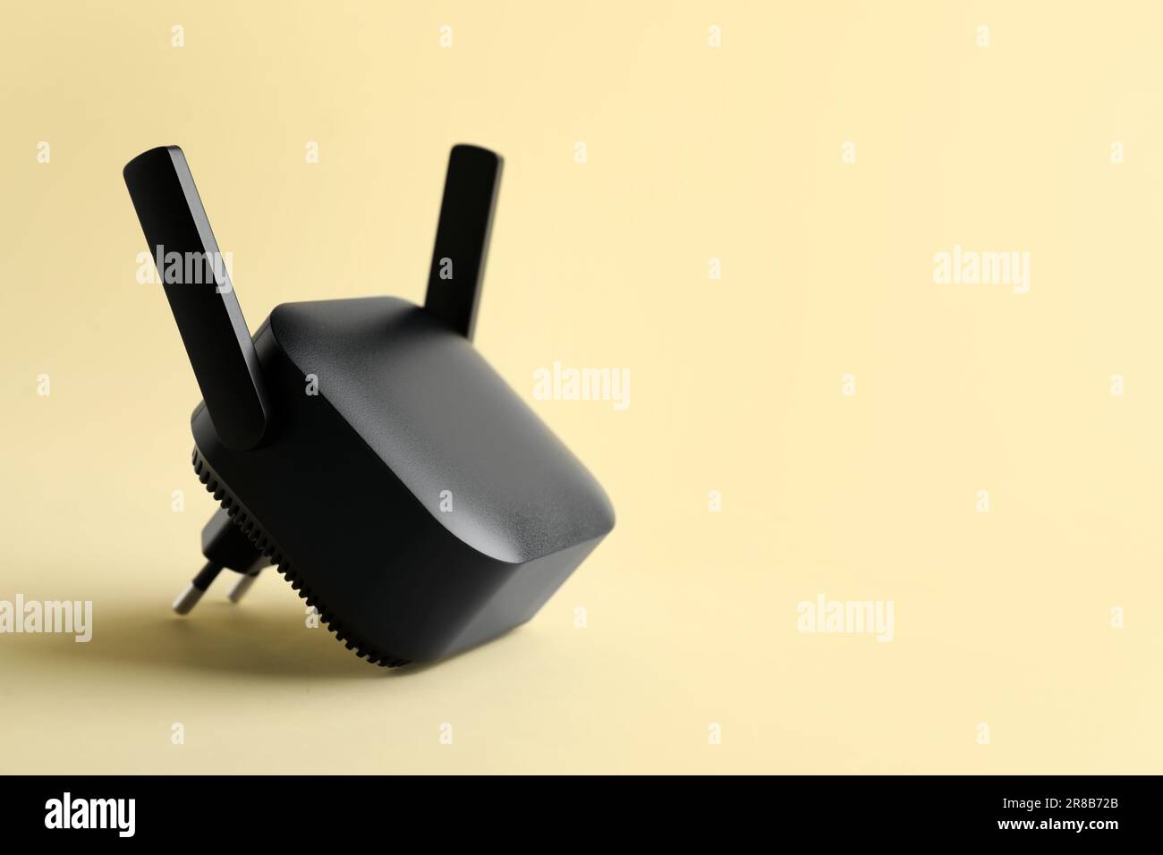 Black WiFi repeater on beige background Stock Photo - Alamy