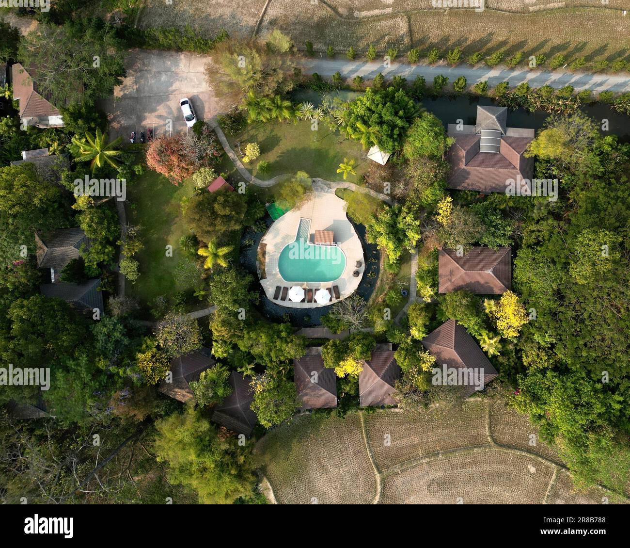 Aerial view of luxurious large mansion estate surrounded by lush green ...