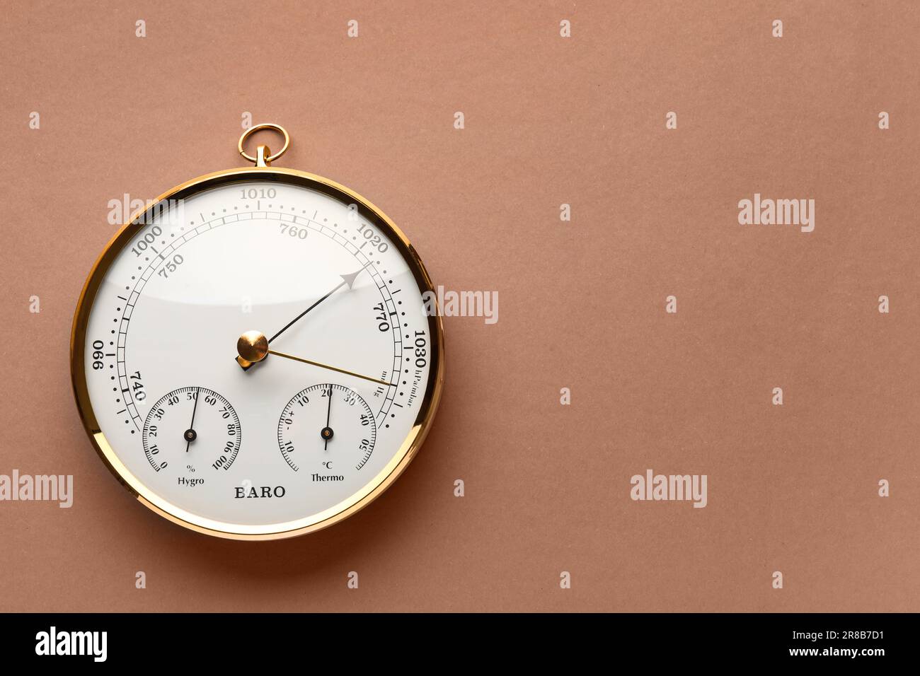 Aneroid barometer on brown background Stock Photo - Alamy