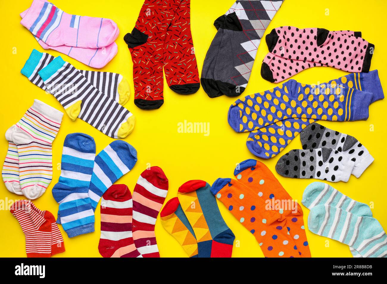 Frame made of different cotton socks on yellow background Stock Photo ...