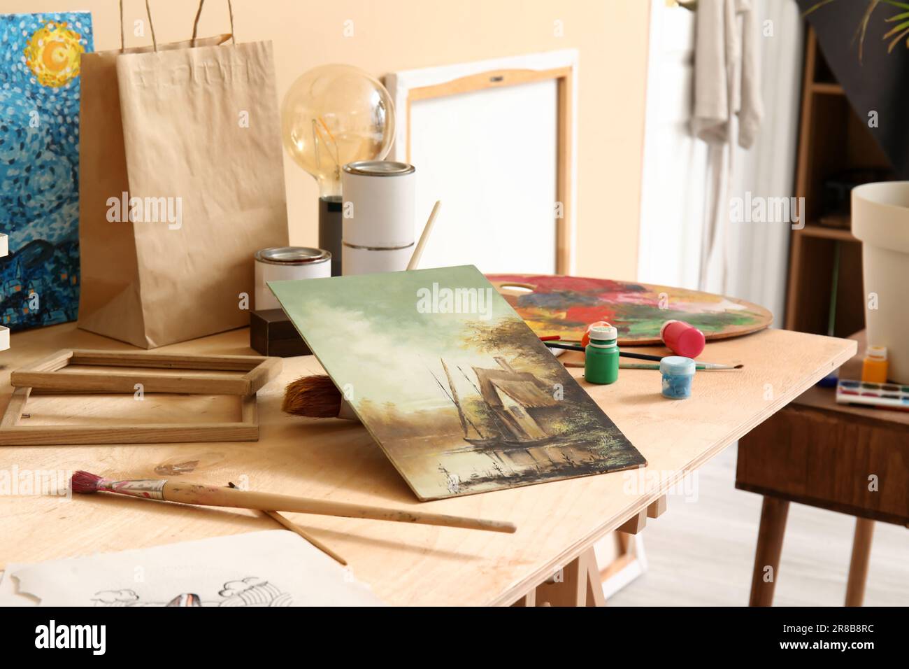 Table with artist's supplies in studio Stock Photo - Alamy