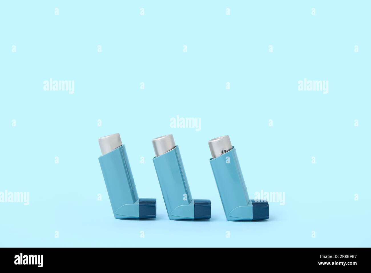 Asthma inhalers on blue background Stock Photo - Alamy