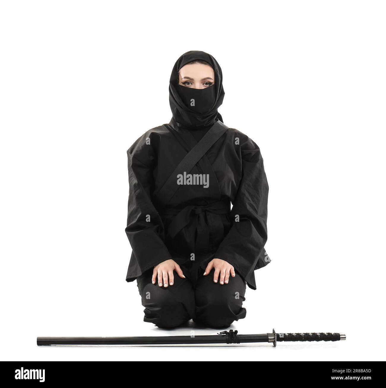 Female ninja with sword on white background Stock Photo - Alamy