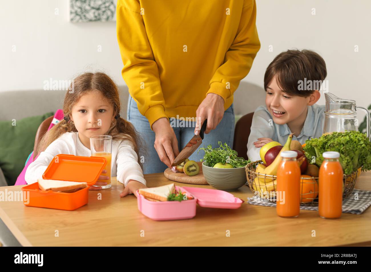 Mother preparing school lunch for her little children in kitchen Stock ...