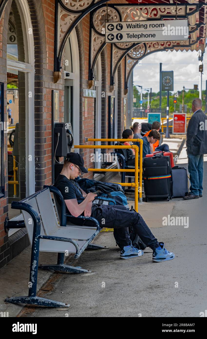 Grantham Train Station – Passengers and travellers waiting on the platform for the arrival of ...