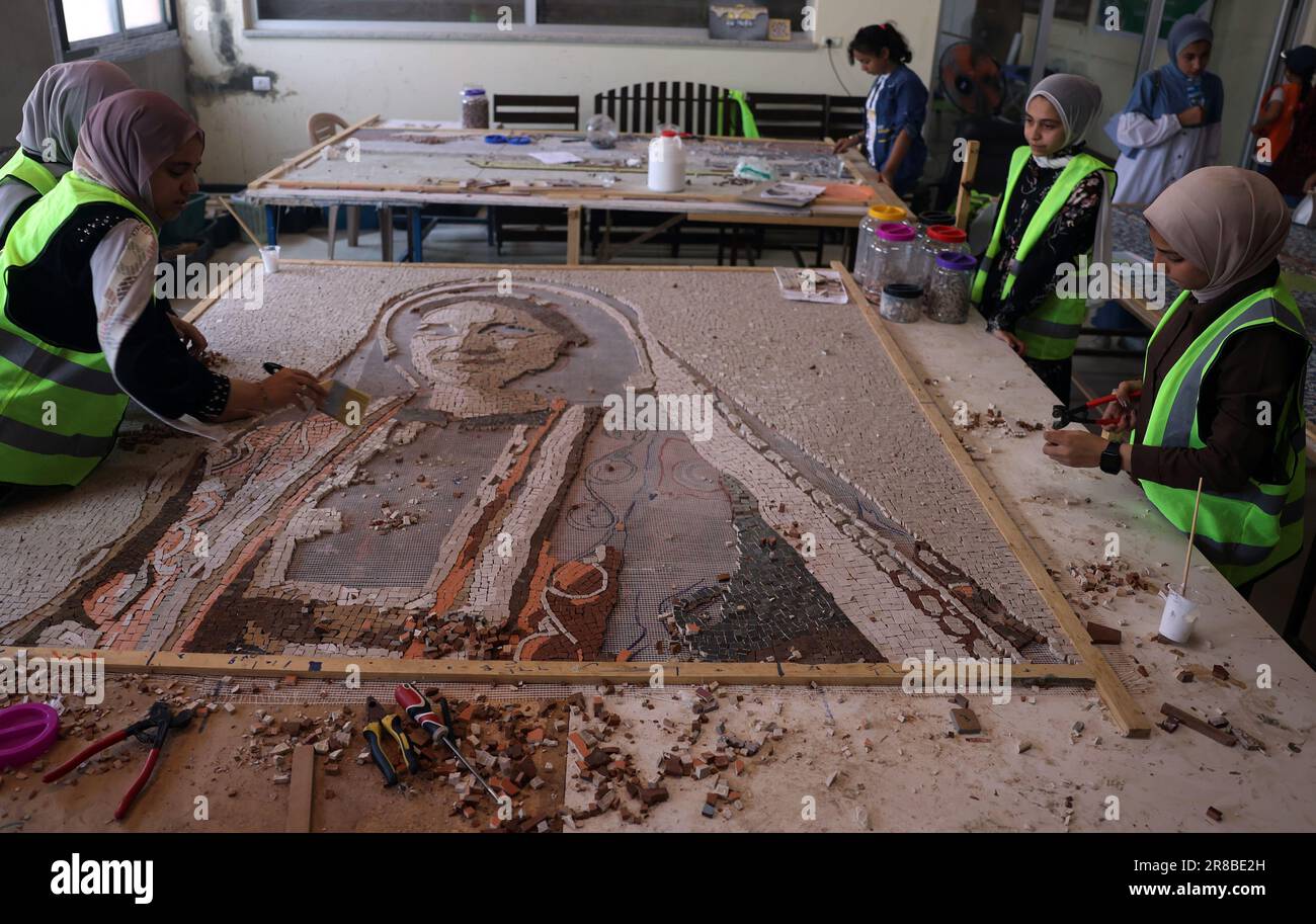 Palestinian girls arranges tiles into a mosaic mural at aassociation in ...