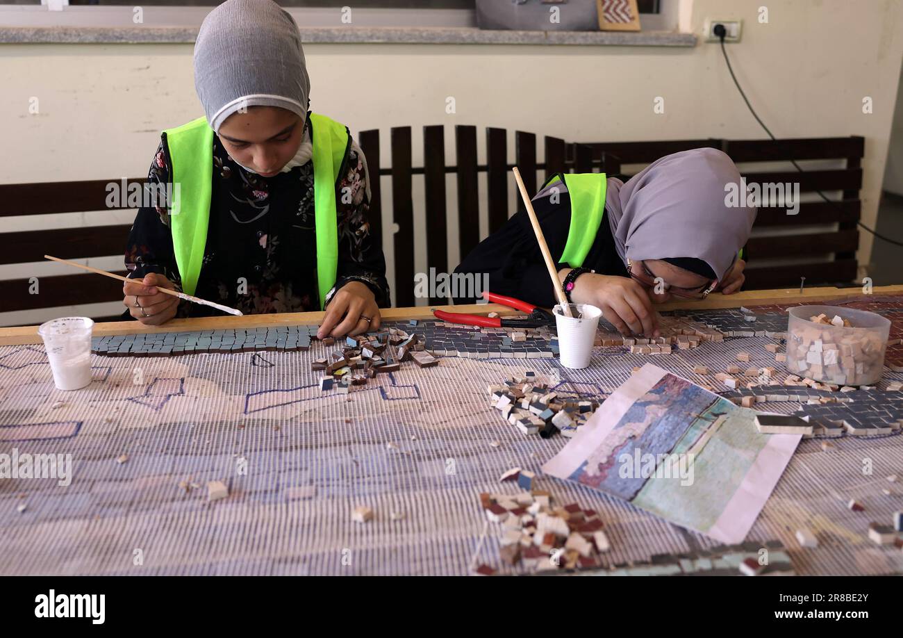 Palestinian girls arranges tiles into a mosaic mural at aassociation in ...