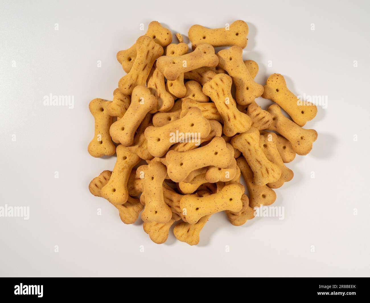Dog biscuits on a white background. Dog treat Stock Photo - Alamy