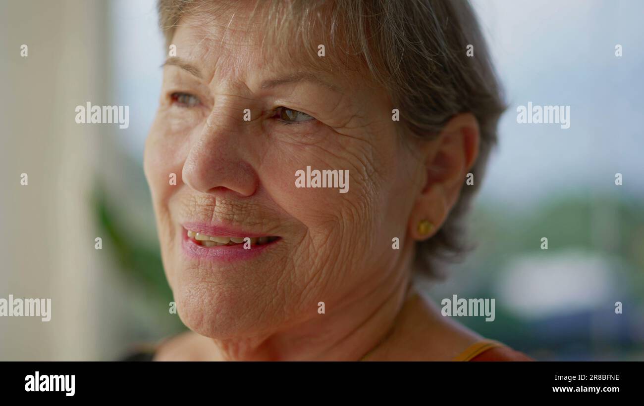 Smiling joyful older woman close-up face feeling free. An older happy ...