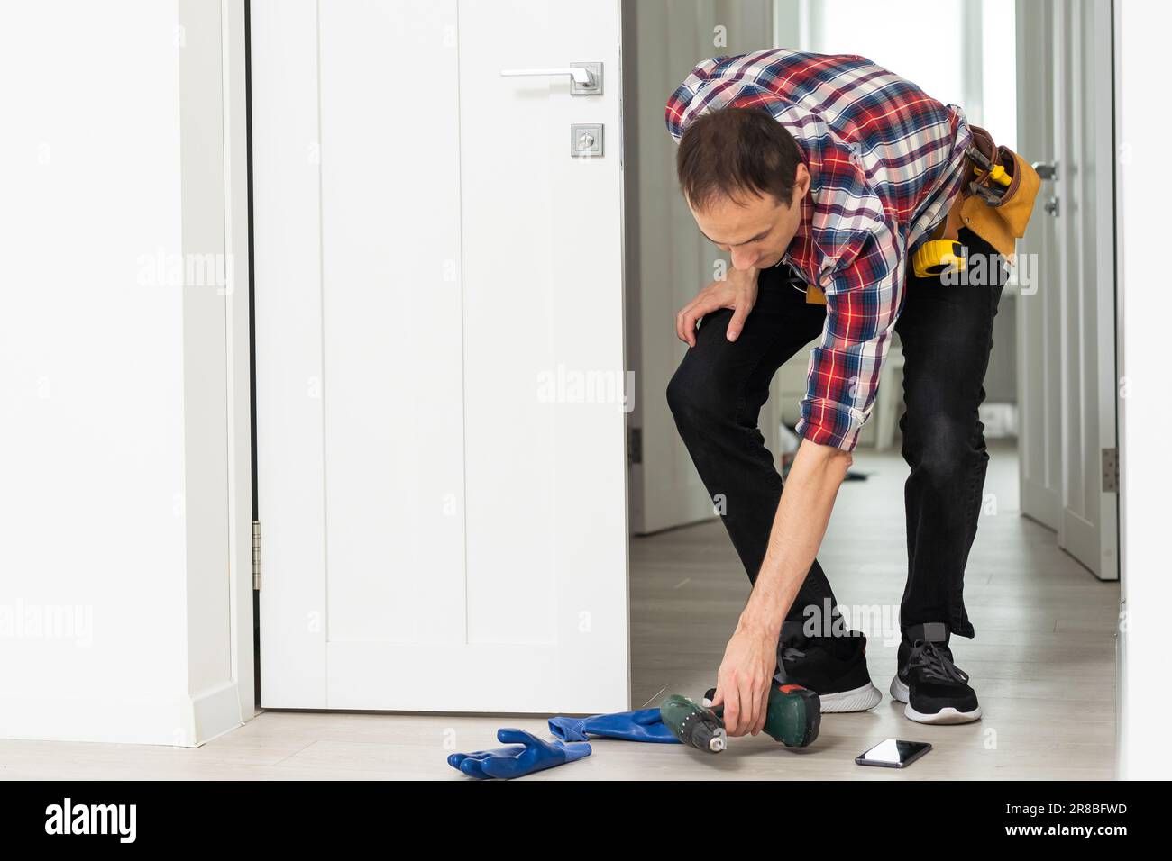 Maintenance Concept. Focused serious young locksmith with tattoo on ...