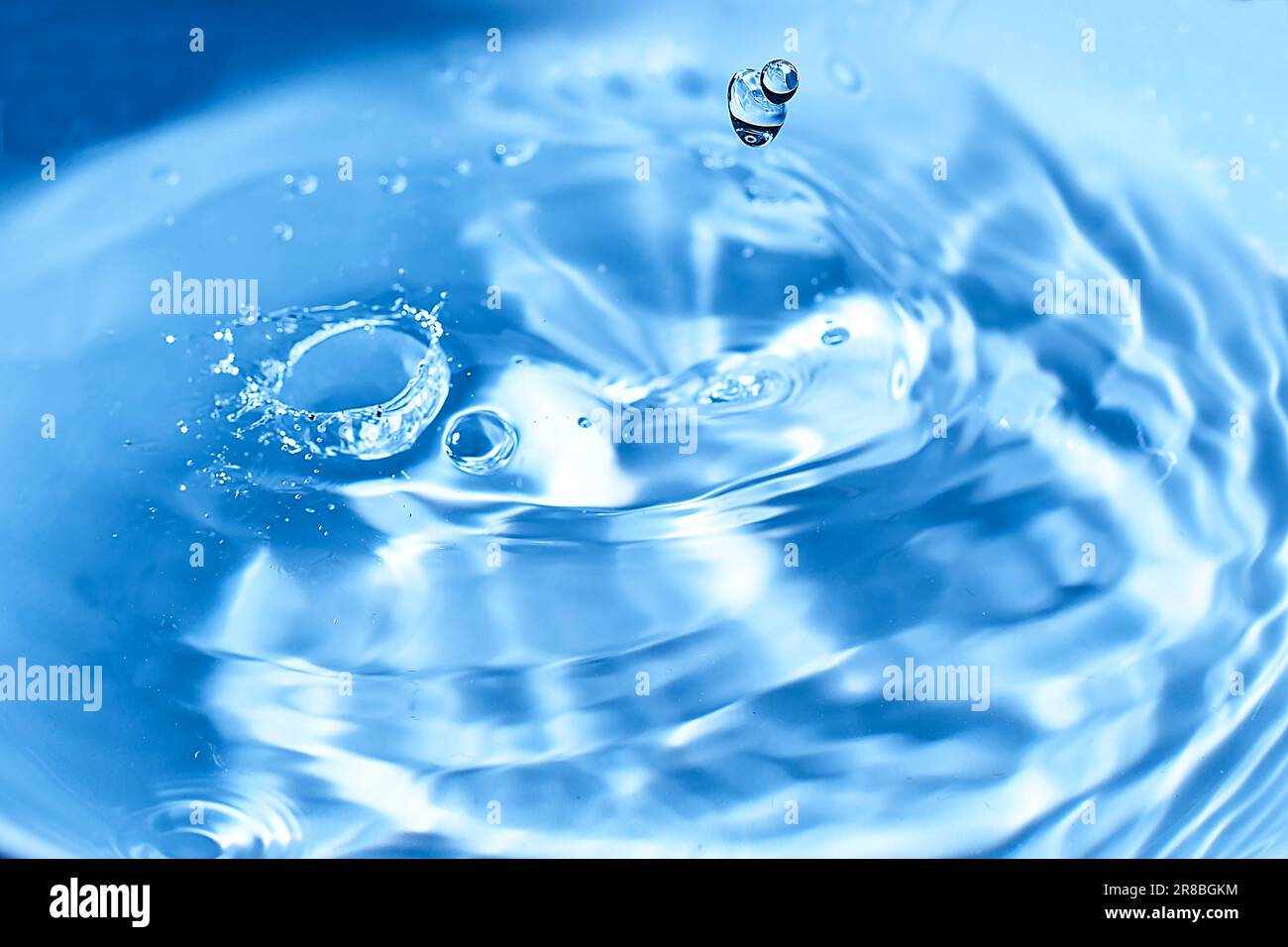 064.One or more drops of water splashing into waves and undefined ...