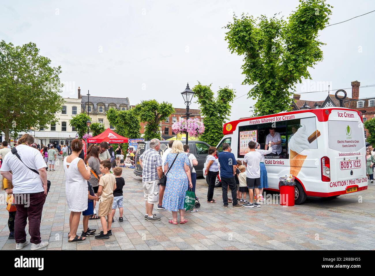 Queue of people waiting ti buy ice creams from an ice cream vendor at ...