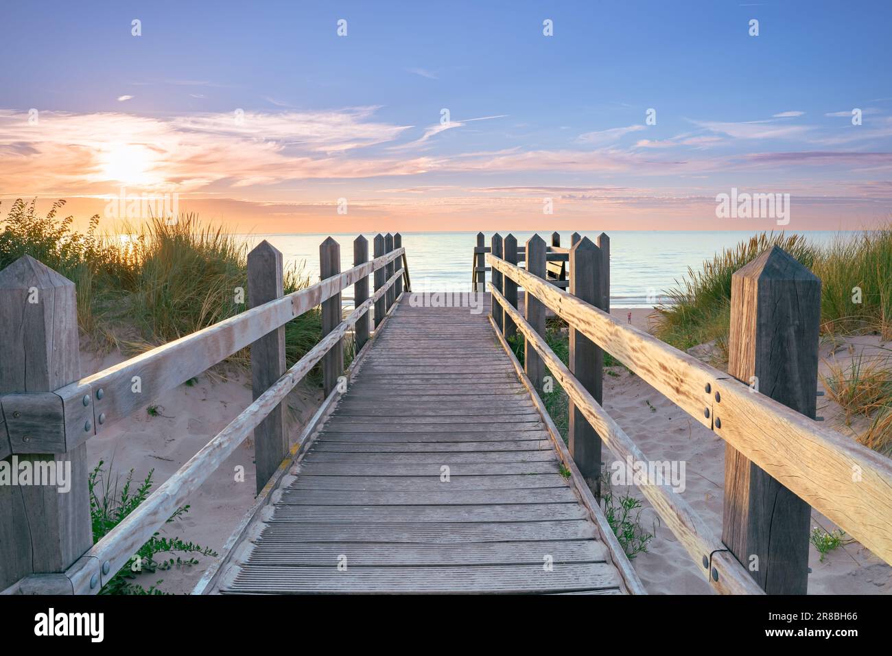 Sunset along the beach with a view over the dunes at a viewpoint with a ...