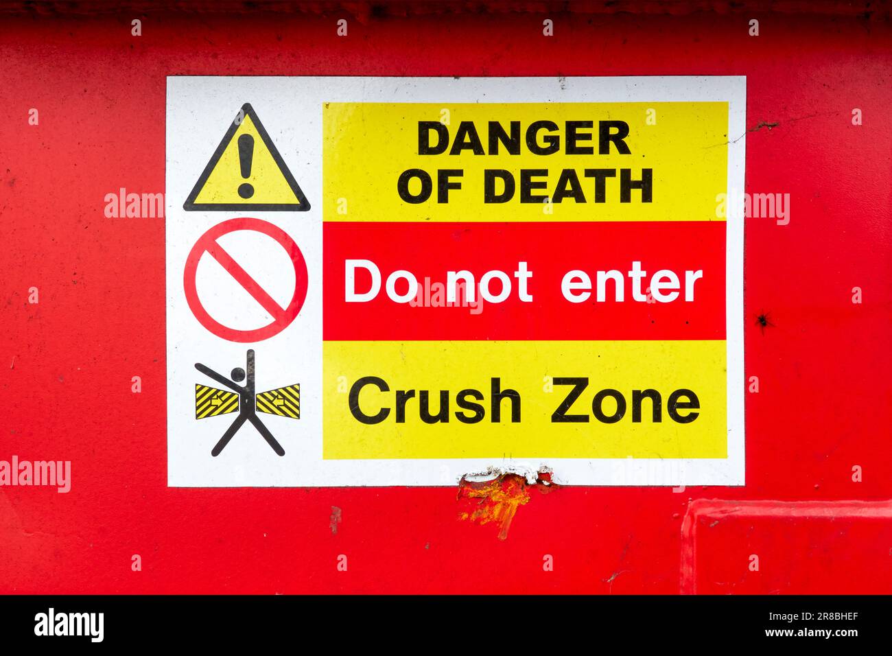 Hazard warning stickers on a red metal recycling skip Stock Photo - Alamy