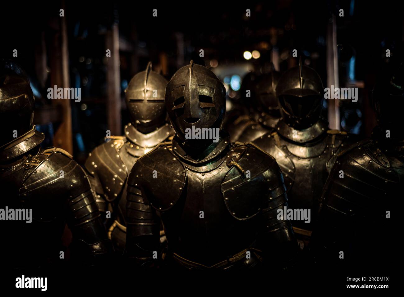 An array of full-sized knights standing in neat rows outdoors in the dark Stock Photo - Alamy