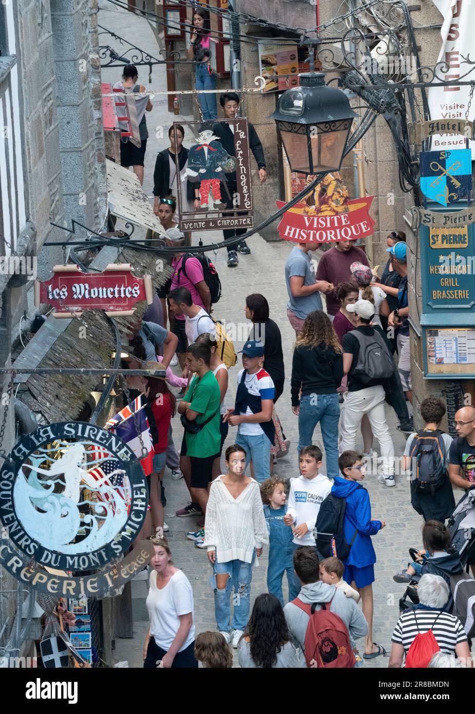 Tourists walk through the commercial alley ways below the 10th-century ...