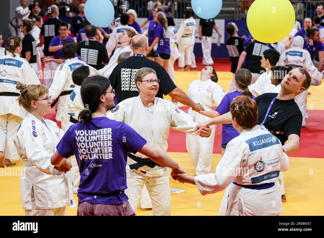 Judo athletes together with judges and collunters go through the ...