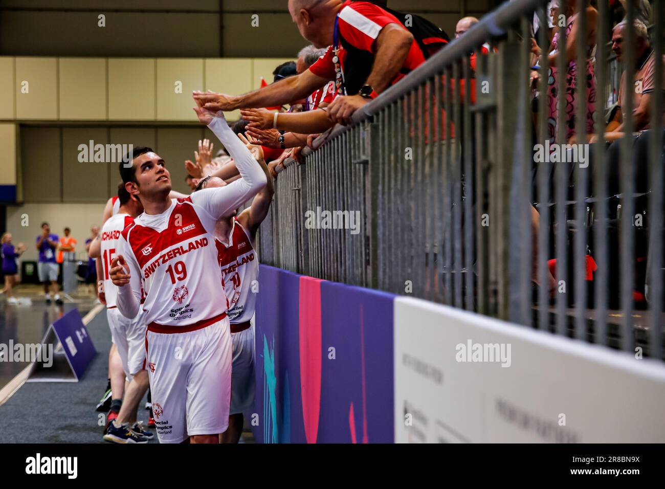 Basketball athletes from Switzerland cheer after winning a match during ...