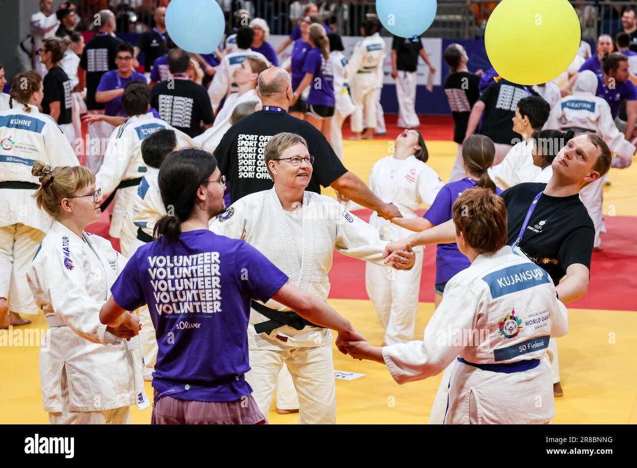 Judo athletes together with judges and collunters go through the ...