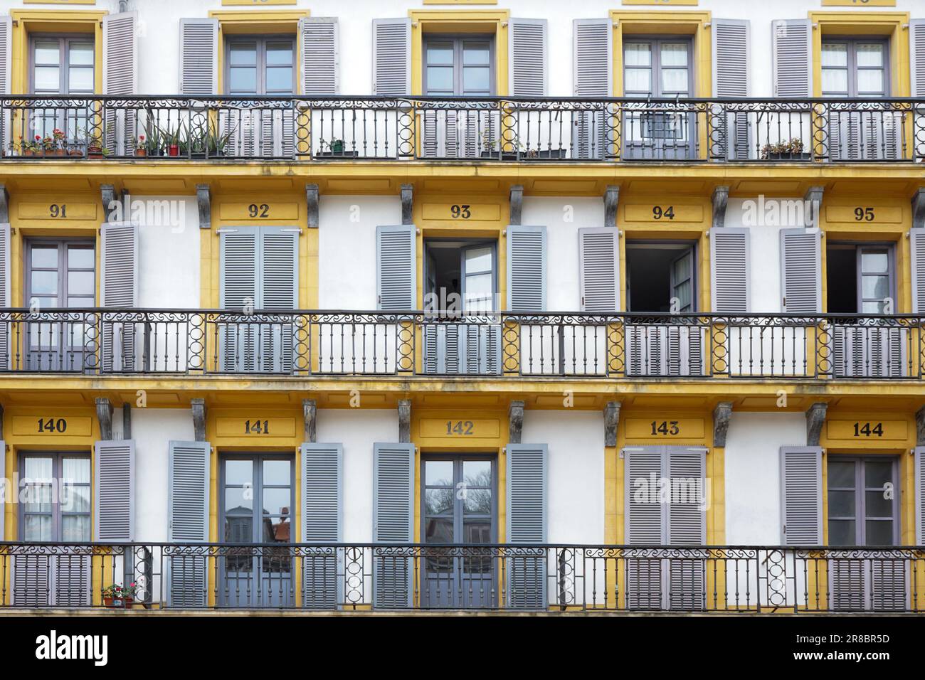 Facade of a residential building with continuous balconies and numbered ...