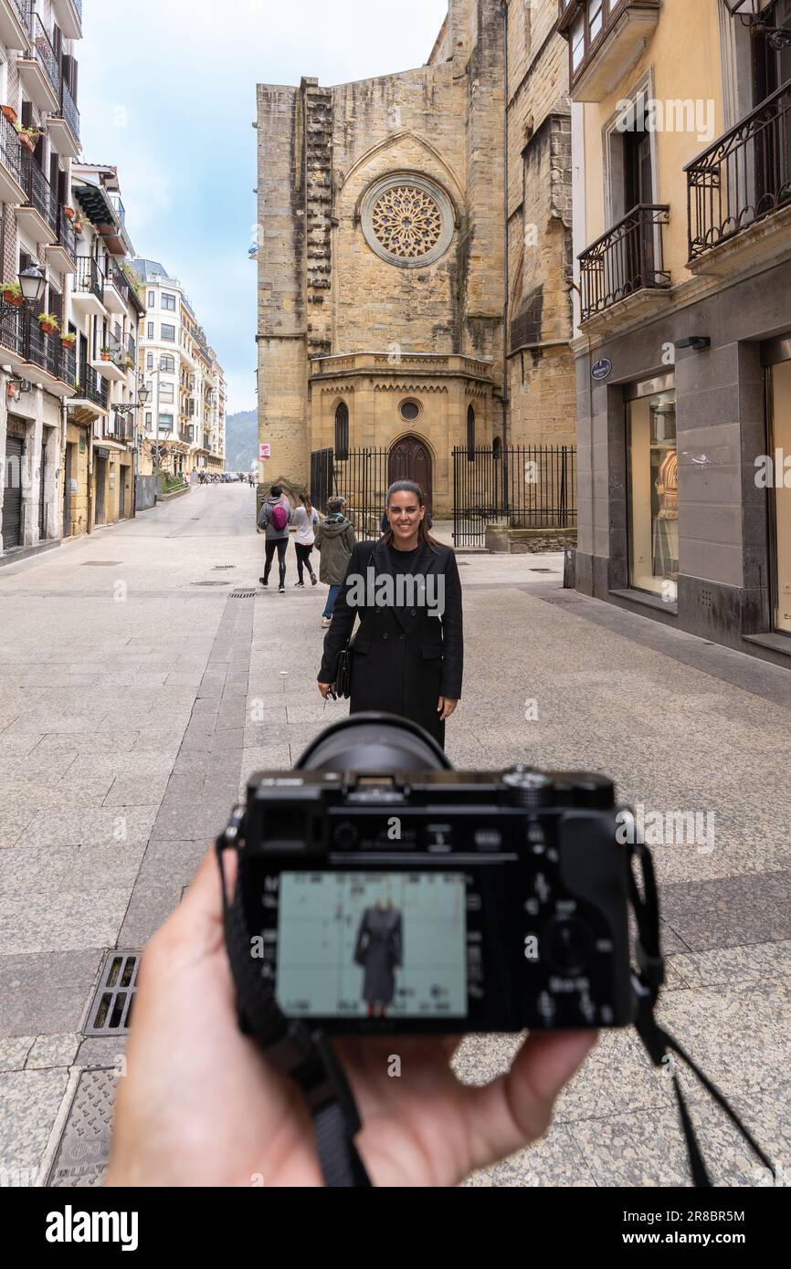 Image of a young tourist woman posing for a photo on a street in San ...