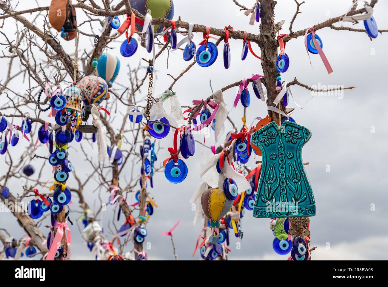 A close-up picture of multiple evil eye charms on a tree, in Uchisar ...