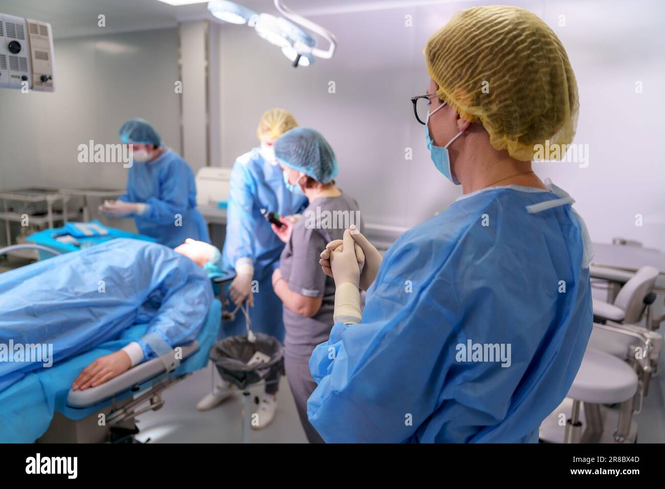Plastic surgeon and nurses doing eyelid surgery on female patient Stock ...