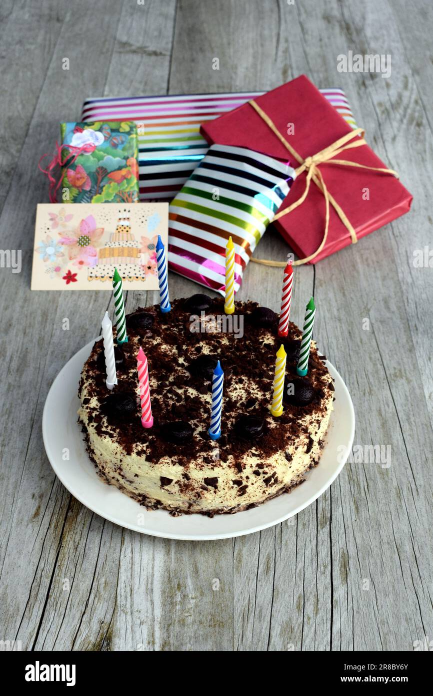 Vertical top view of homemade birthday cake with colorful candles and ...
