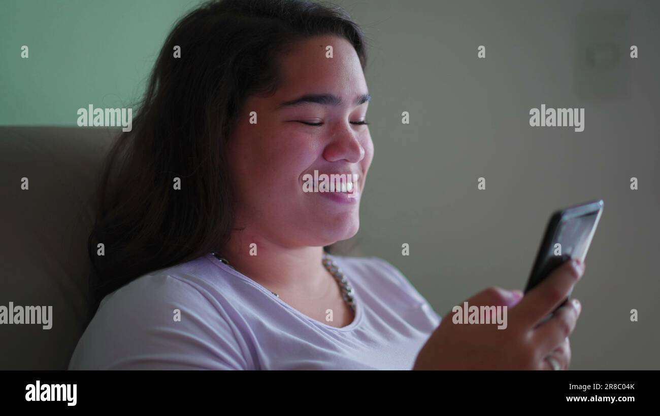Happy Brazilian Teen Girl Reacts Positively to Online Content, Holding ...