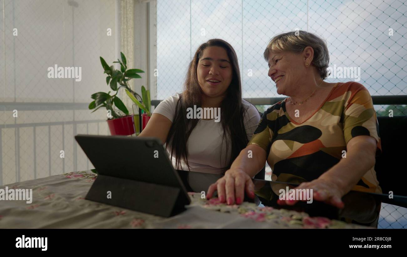 Joyful Grandmother In Front Of Tablet Device With Her Diverse Asian 1147