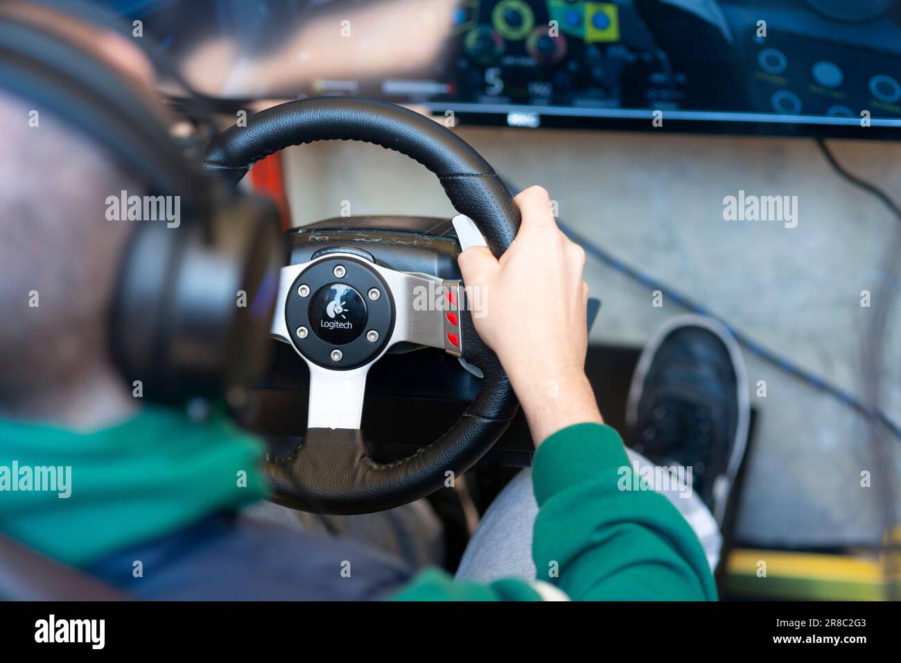 Hands of a Man on a Steering Wheel, While he Plays a Racing Game Stock ...